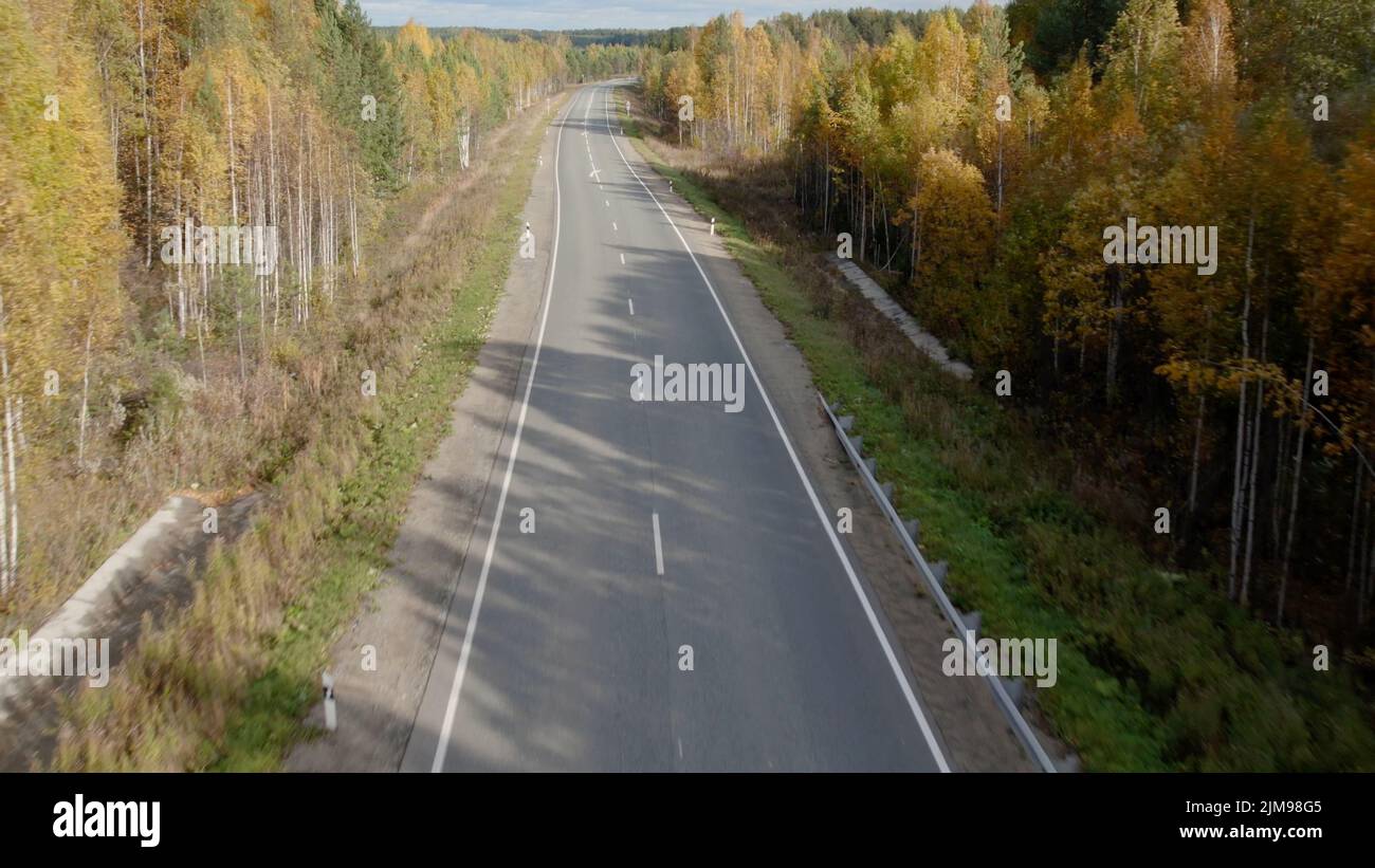 Asphalt road with traffic cars between forest in Ural, Russia ...