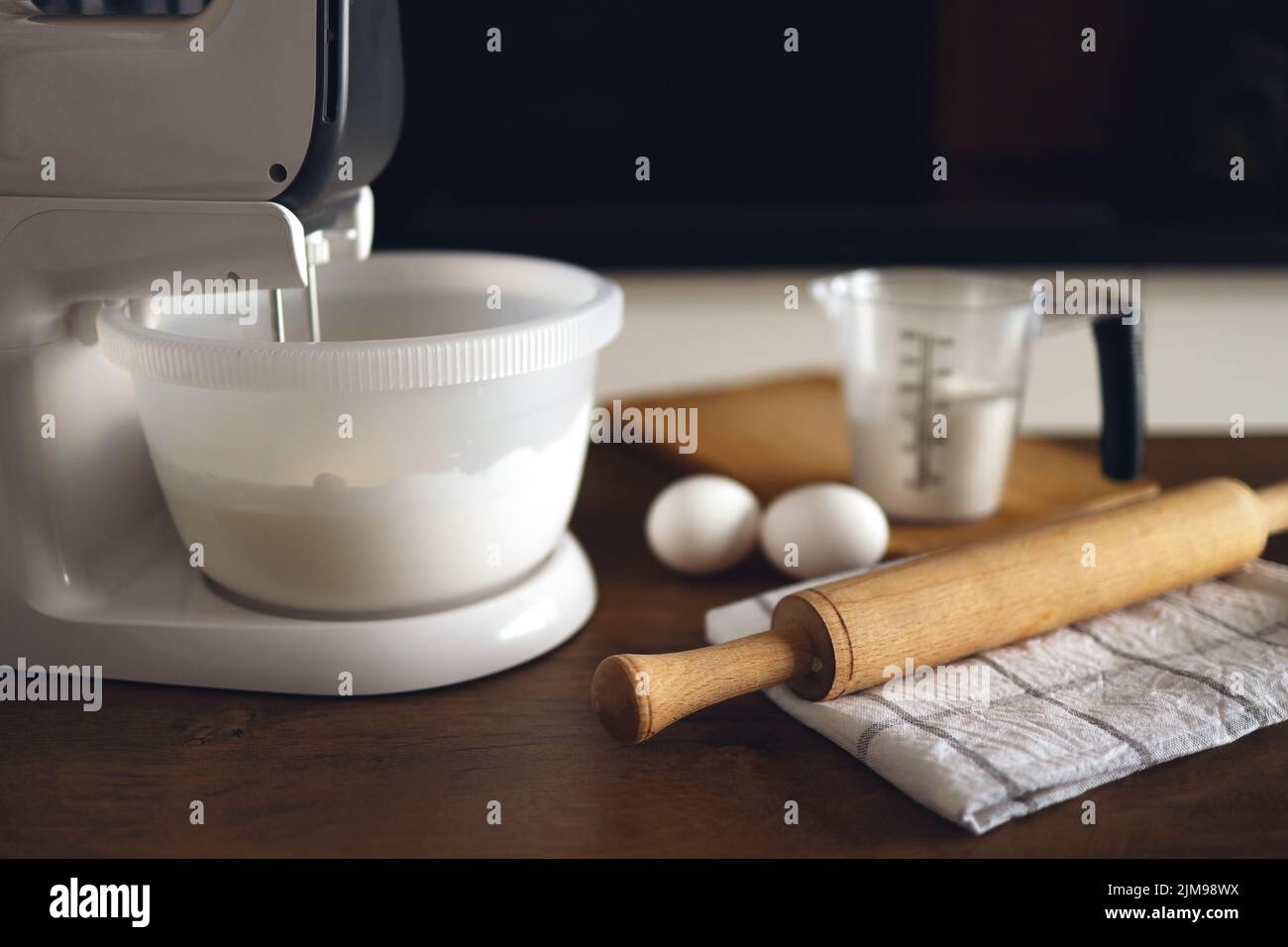 Closeup of a table in a home kitchen with a mixer and products for ...