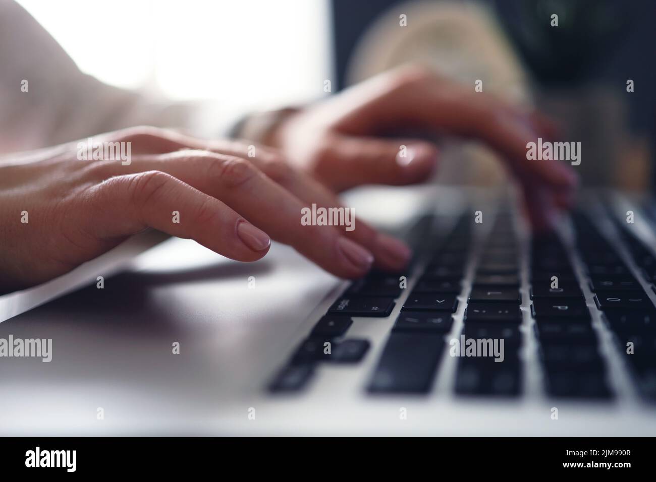 Female young hands with manicure typing text on laptop. Working with ...