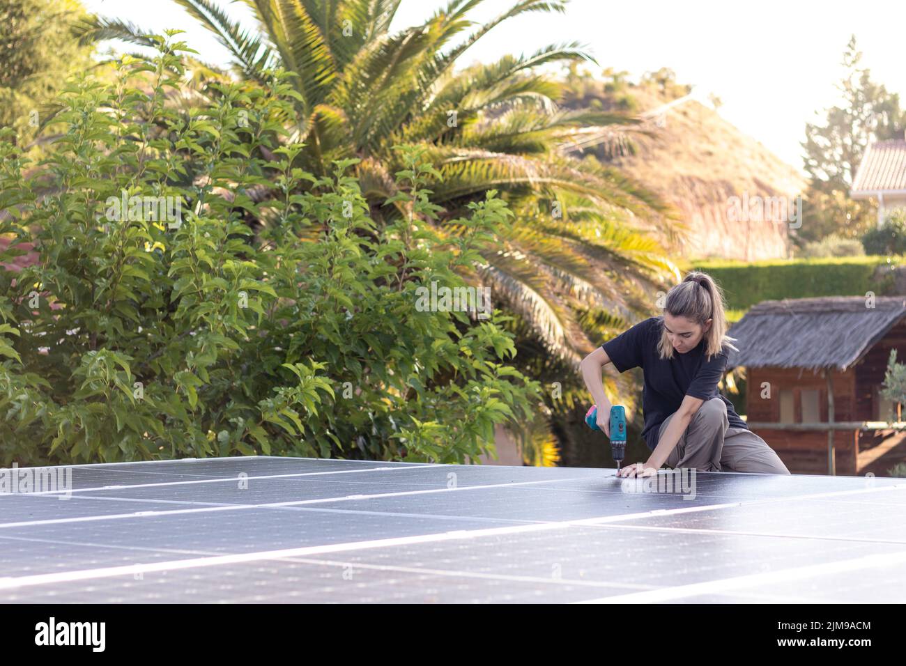 Young woman techinician hard working and concentrated in a solar panel ...