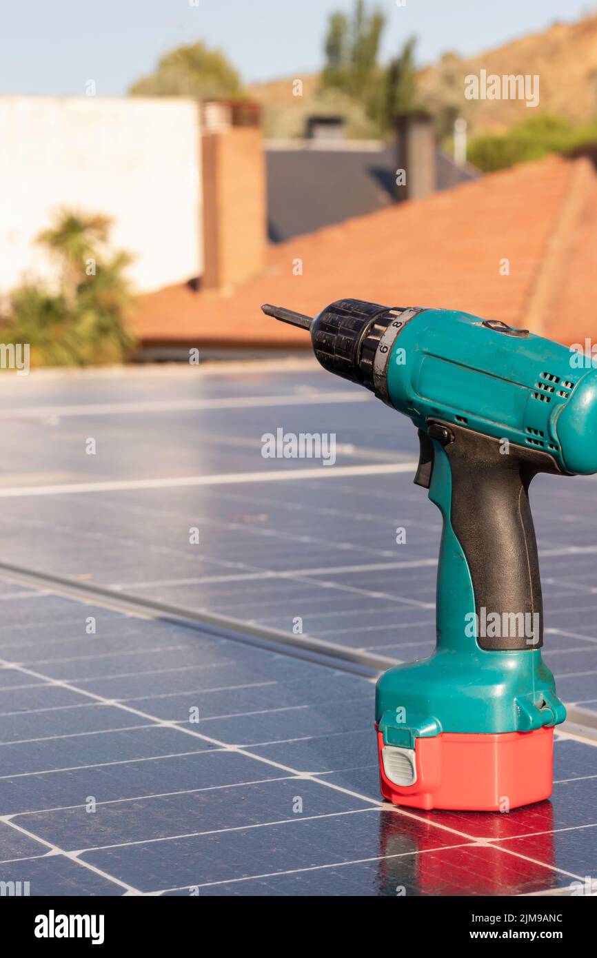 Vertical close up view of blue and red electric screwdriver on a solar ...