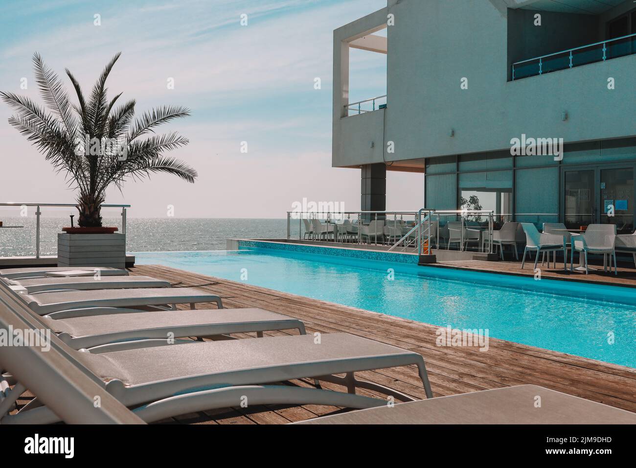 Summer outdoor swimming pool and sun loungers. In the hotel to rest ...