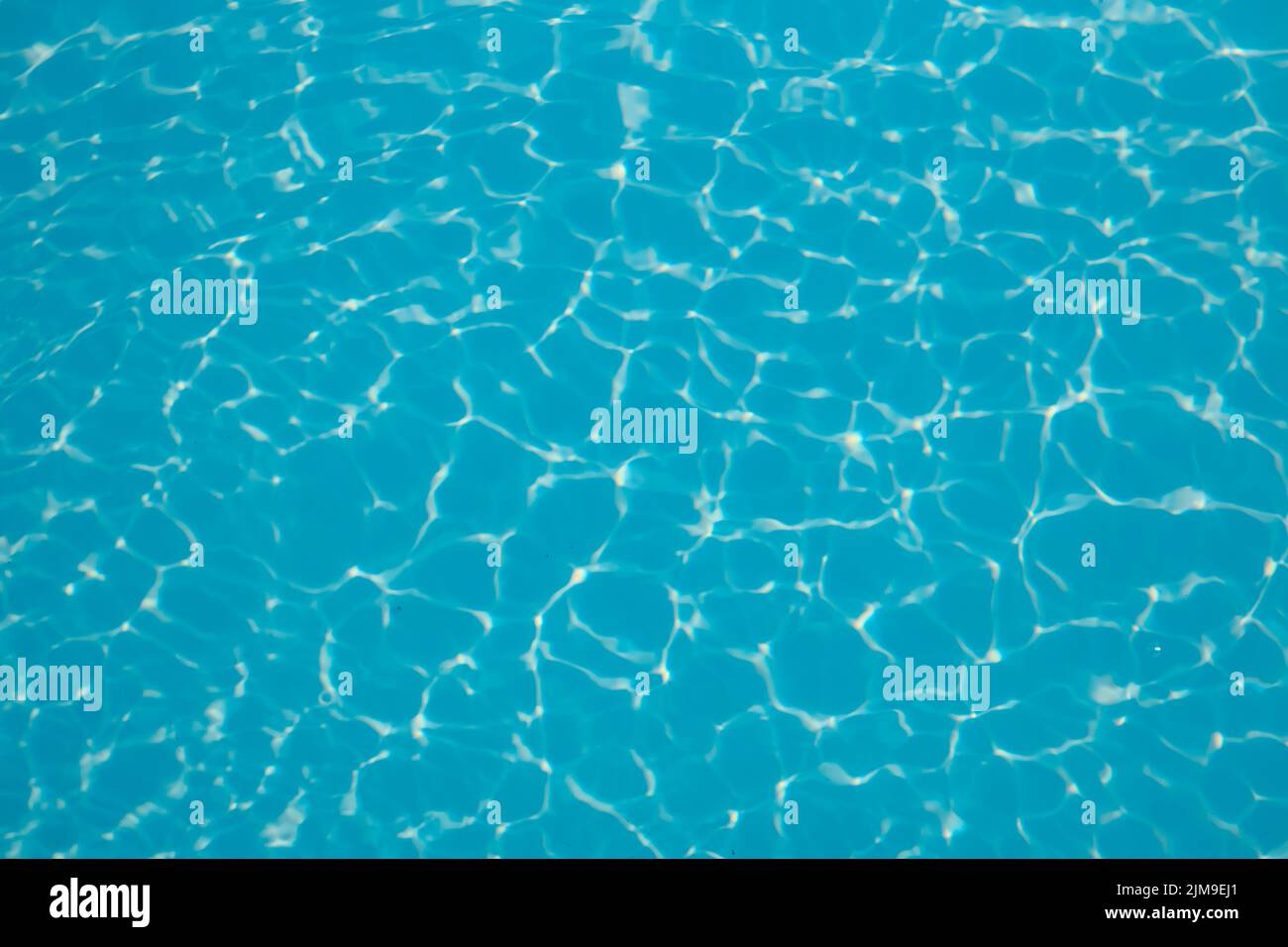Abstract background of sparkling cool blue water in a swimming pool ...