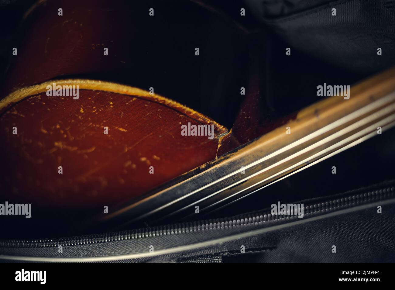 String of old shabby cello Stock Photo - Alamy