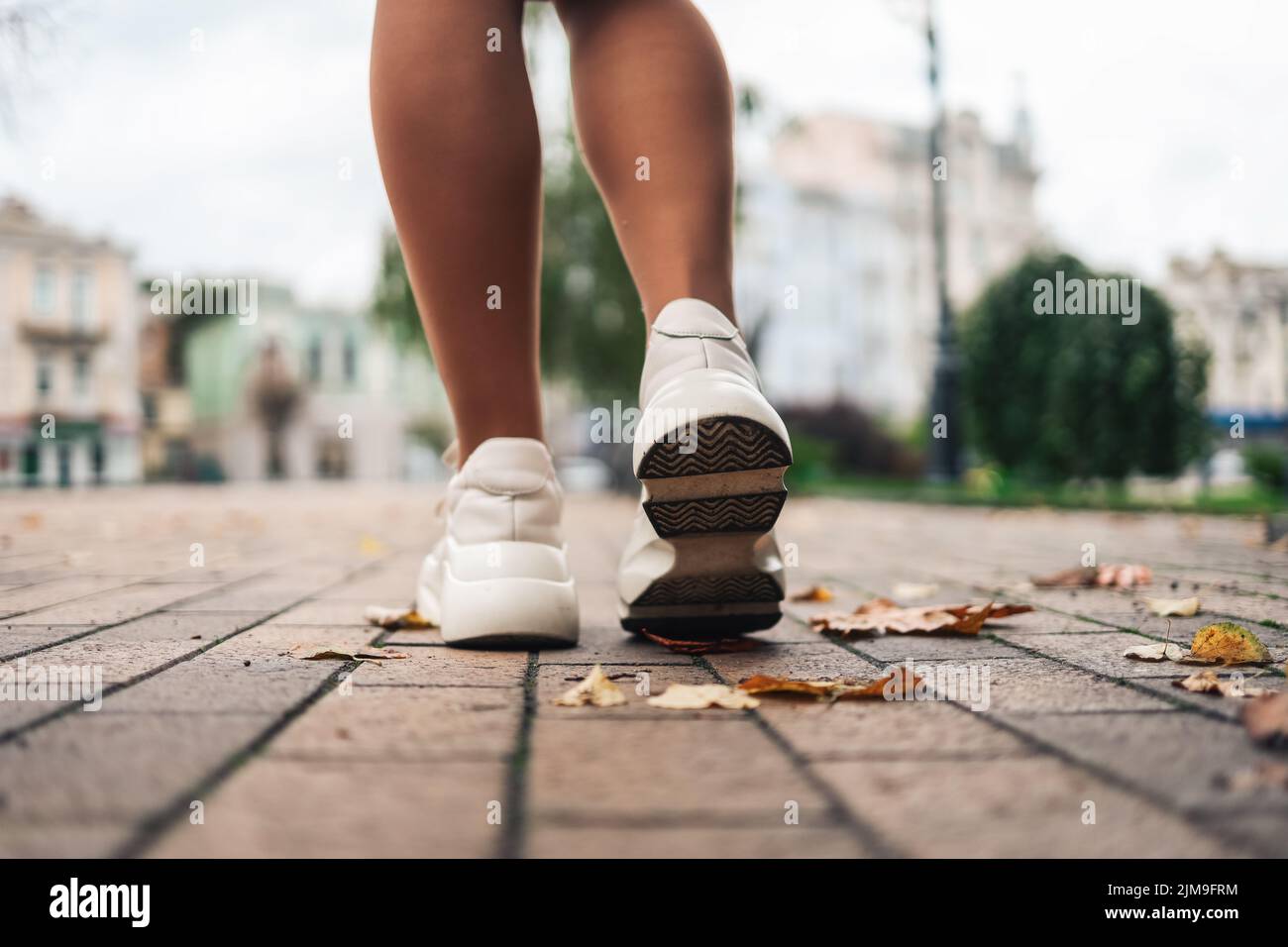 Close up of feet of a runner running in autumn leaves training for ...