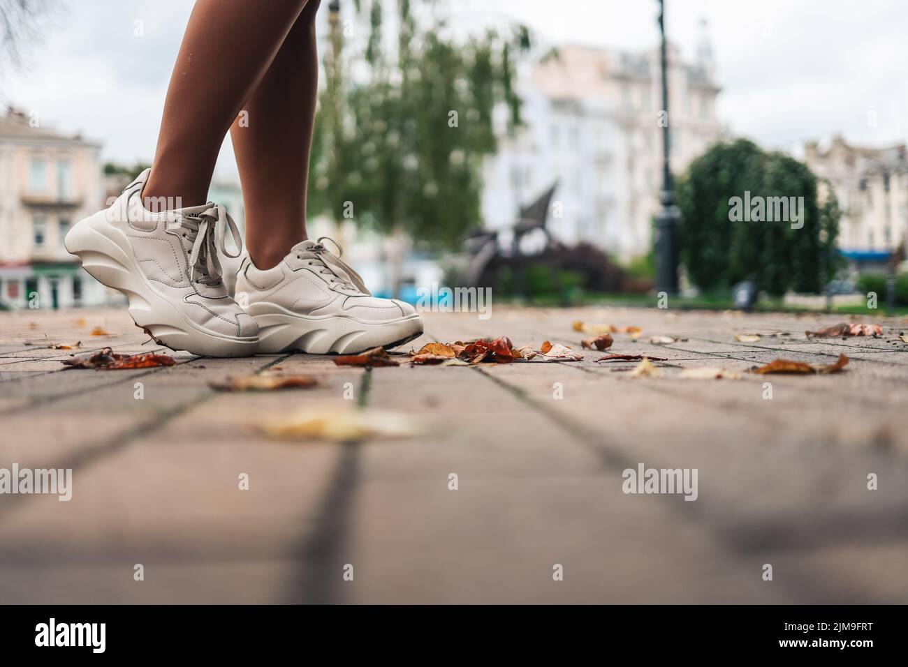 Close up of feet of a runner running in autumn leaves training for ...