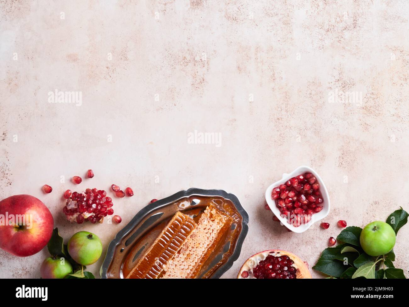 Rosh Hashanah. Honey jar, honeycomb, apple and pomegranate on light ...