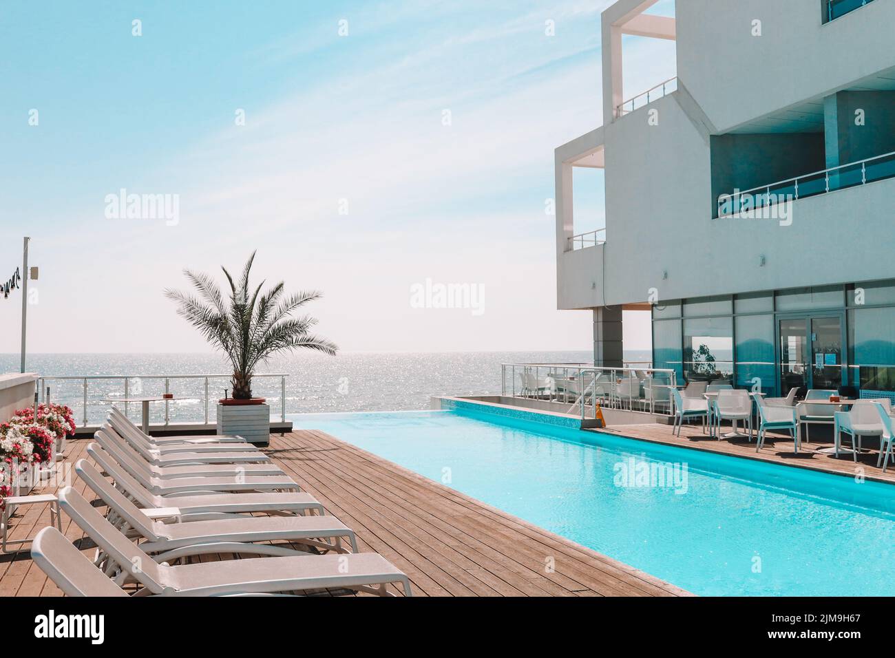 Summer outdoor swimming pool and sun loungers. In the hotel to rest ...