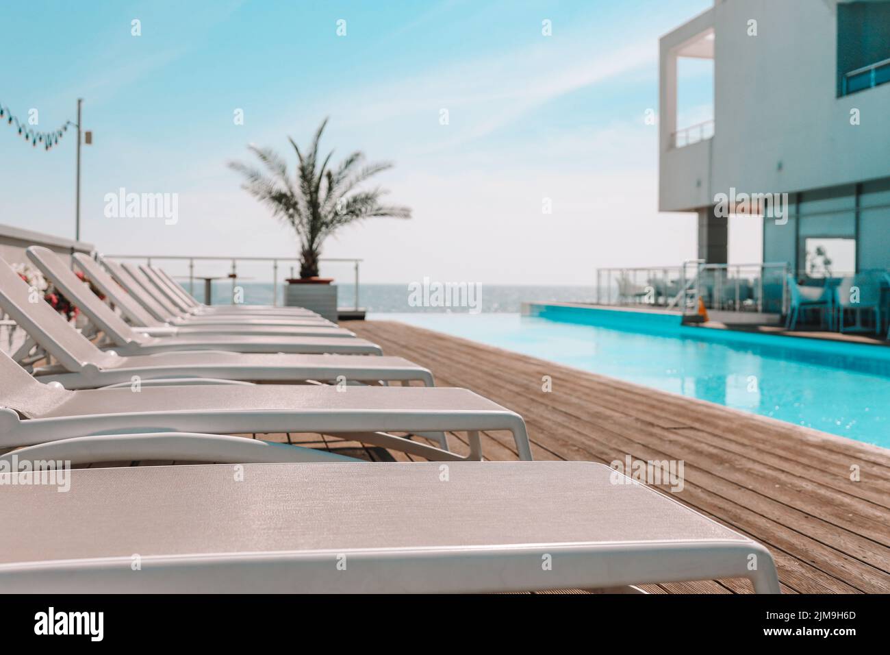 Summer outdoor swimming pool and sun loungers. In the hotel to rest ...