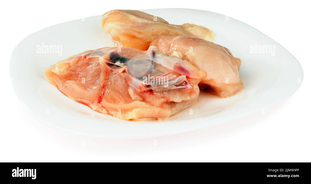 Fresh filleted chicken on porcelain plate over white background Stock ...