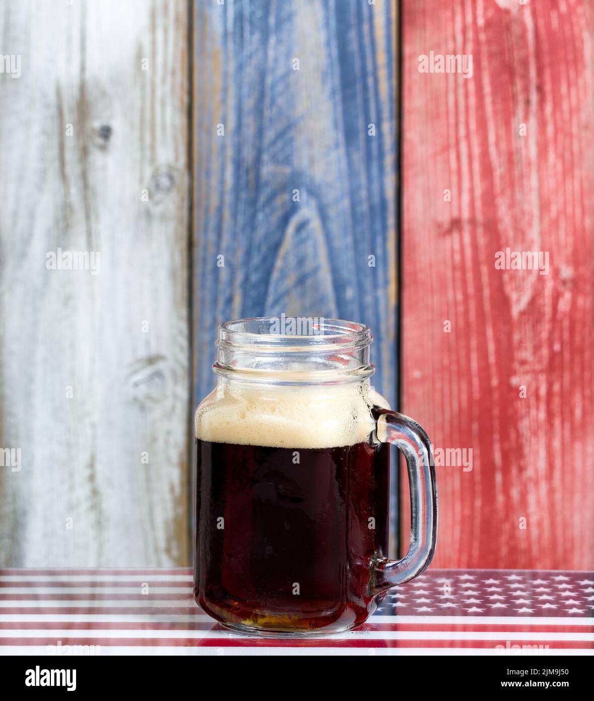 Single beer with faded wooden boards painted in USA national colors ...