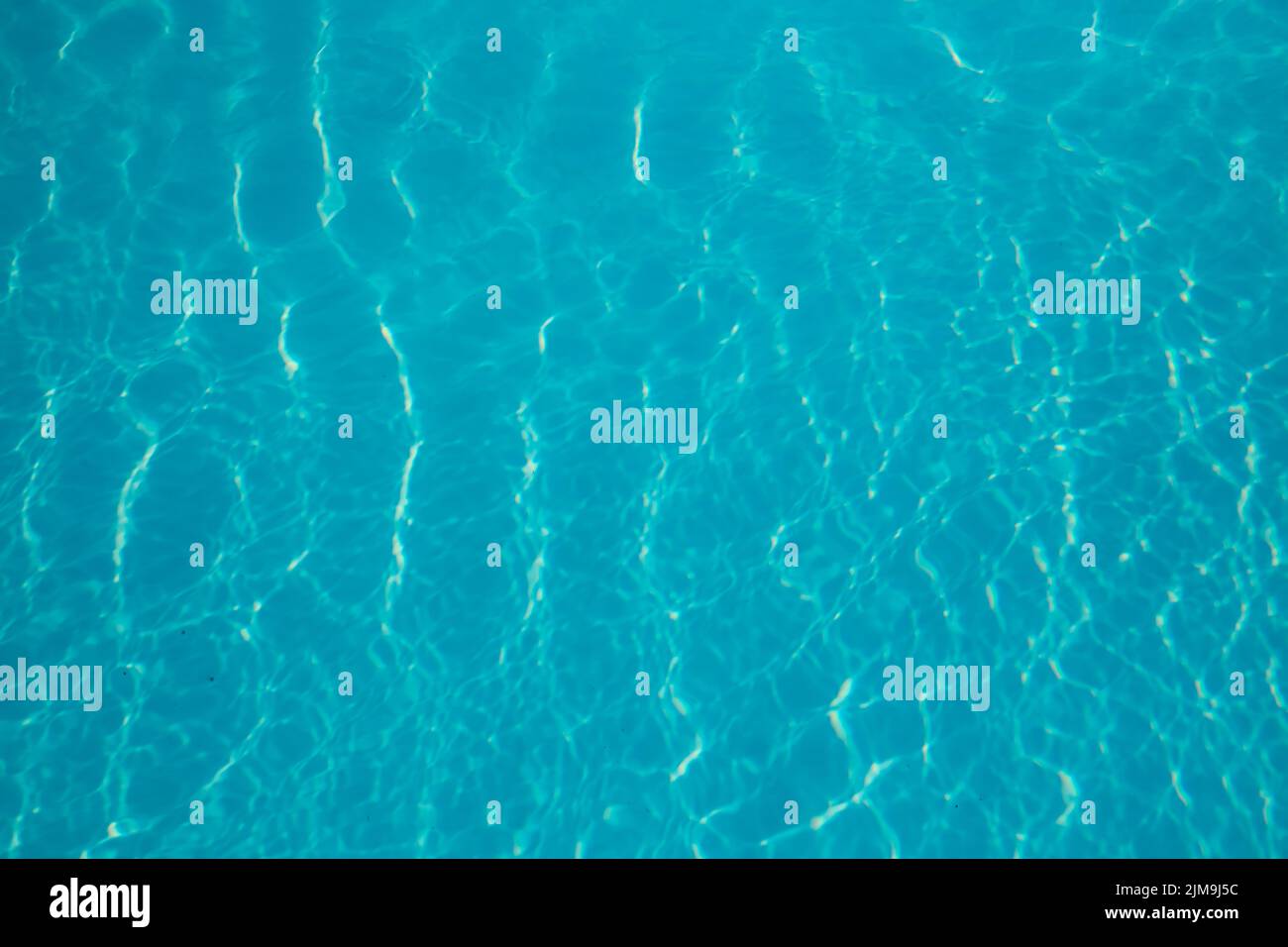 Abstract background of sparkling cool blue water in a swimming pool ...