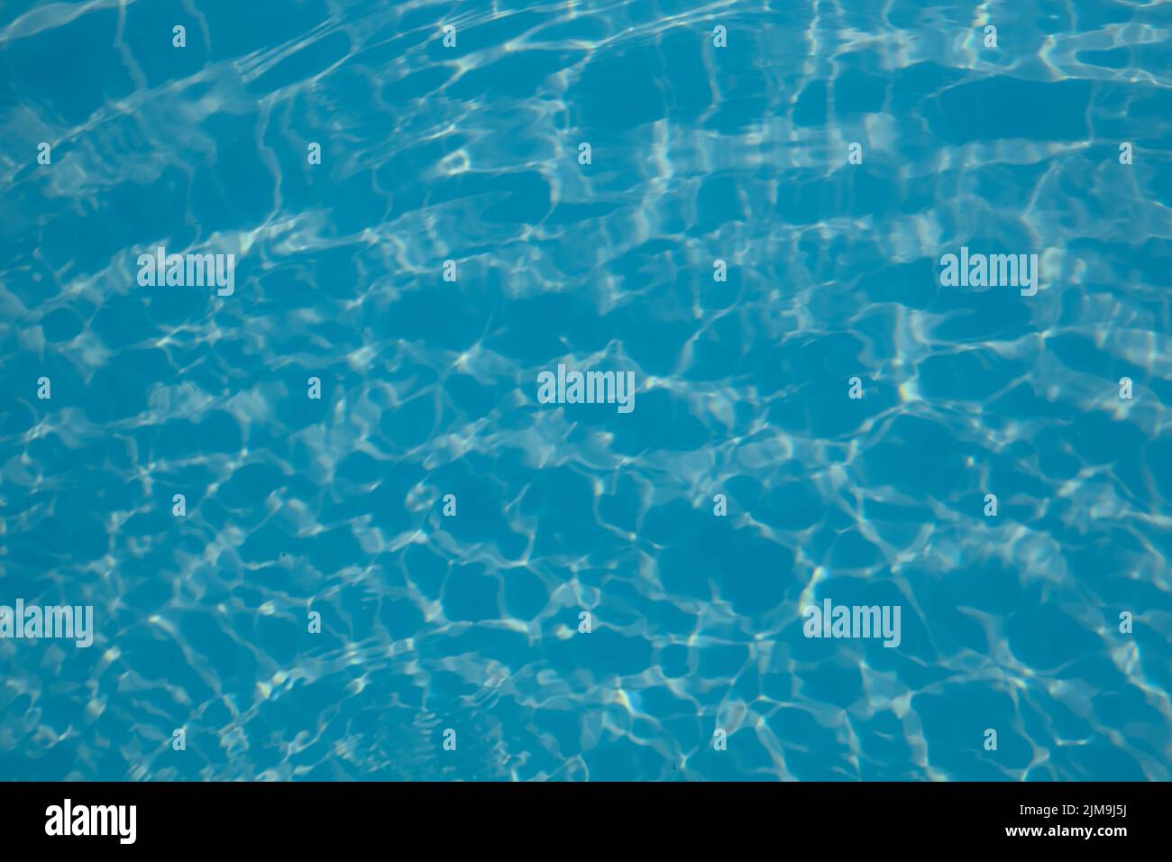 Abstract background of sparkling cool blue water in a swimming pool ...