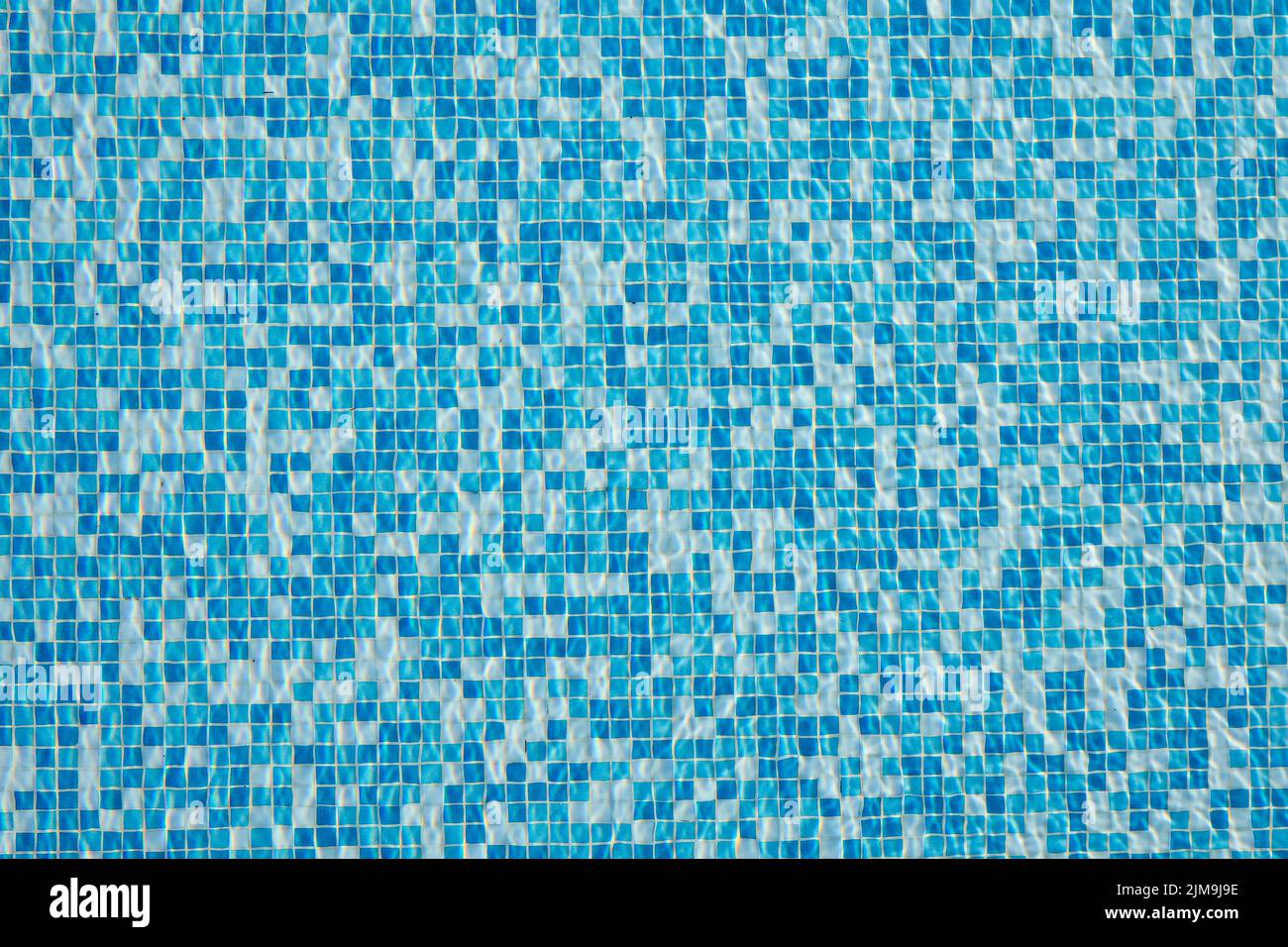 Abstract background of sparkling cool blue water in a mosaic swimming ...