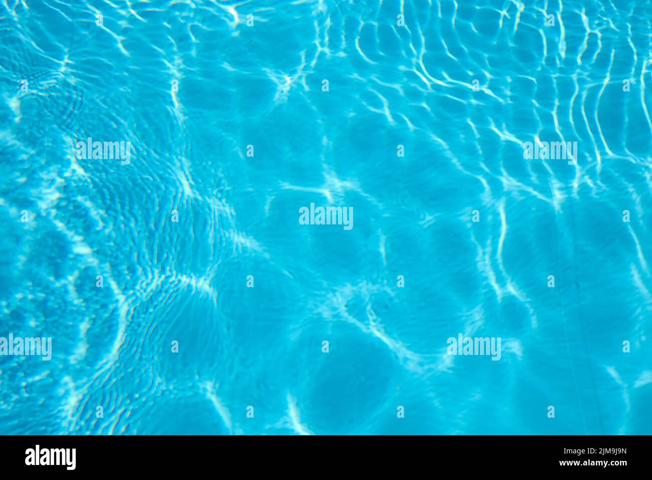 Abstract background of sparkling cool blue water in a swimming pool ...