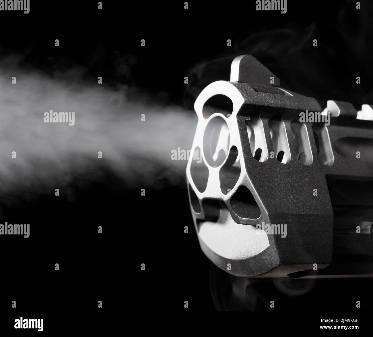 Handgun with smoke coming out of the barrel on black Stock Photo - Alamy
