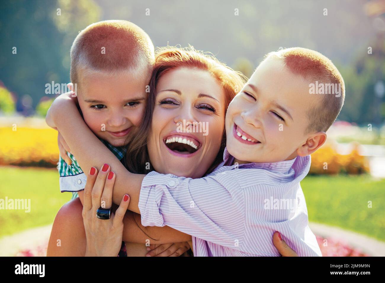 Happy mother sons hug park summer Stock Photo - Alamy
