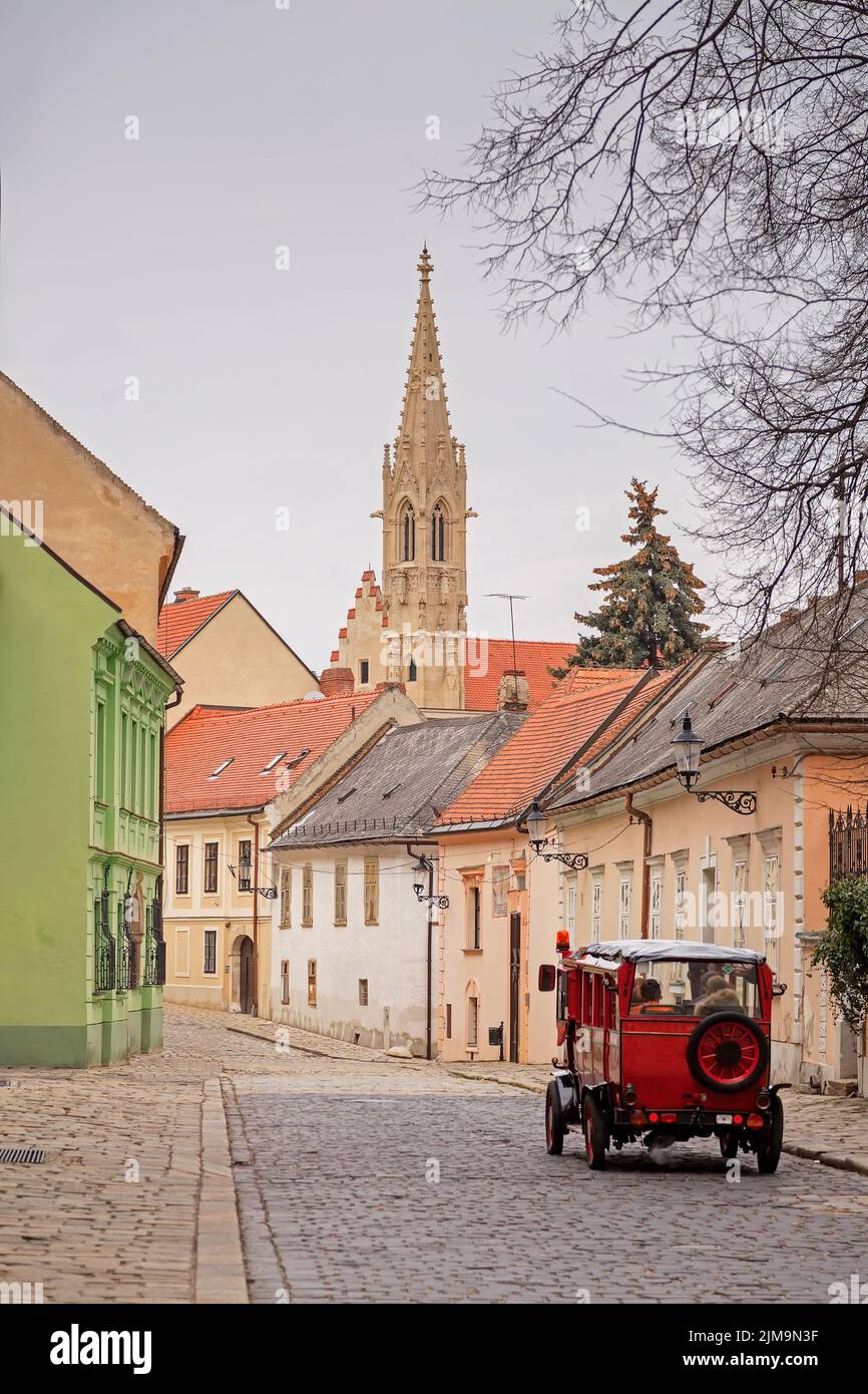 Catholic cathedral and vintage car on old street Stock Photo - Alamy
