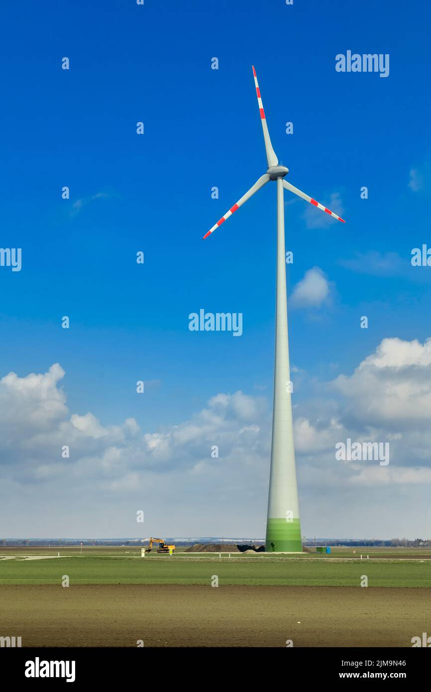 Rotating windmill blades in blue sky Stock Photo - Alamy