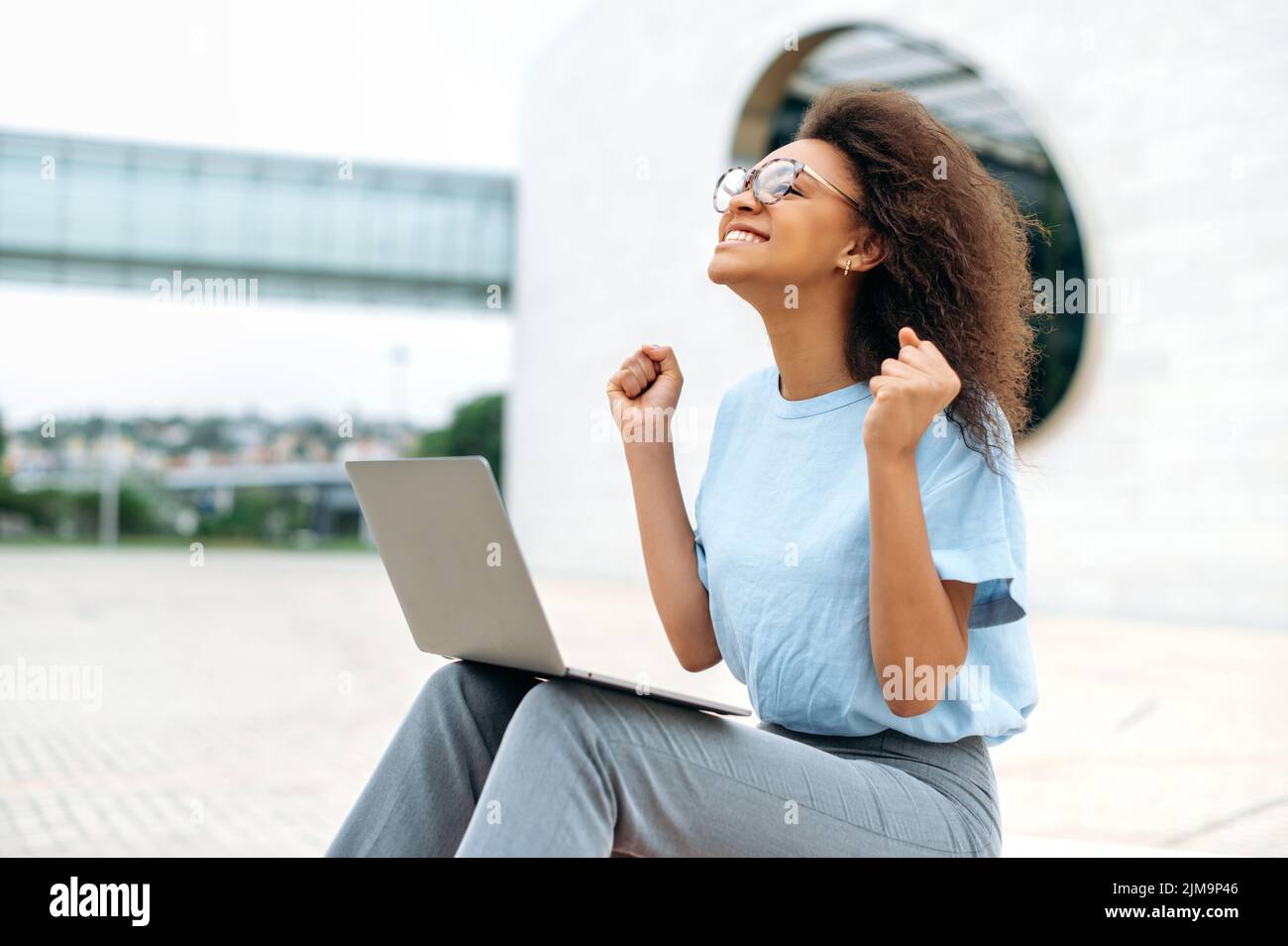 Happy mixed race female celebrate success. Joyful african american ...