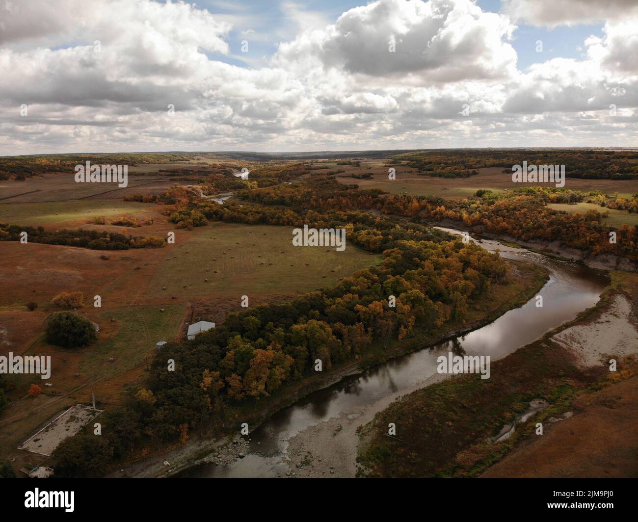 An aerial view of a winding river in plains on a cloudy morning Stock ...