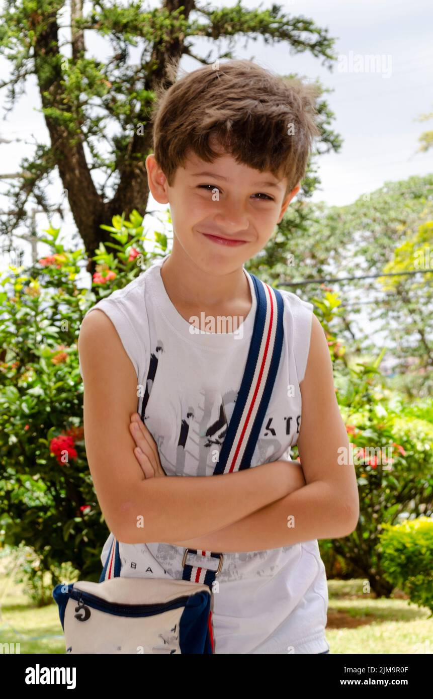 Portrait of a cheerful boy counts trees background. Concept of joy and ...