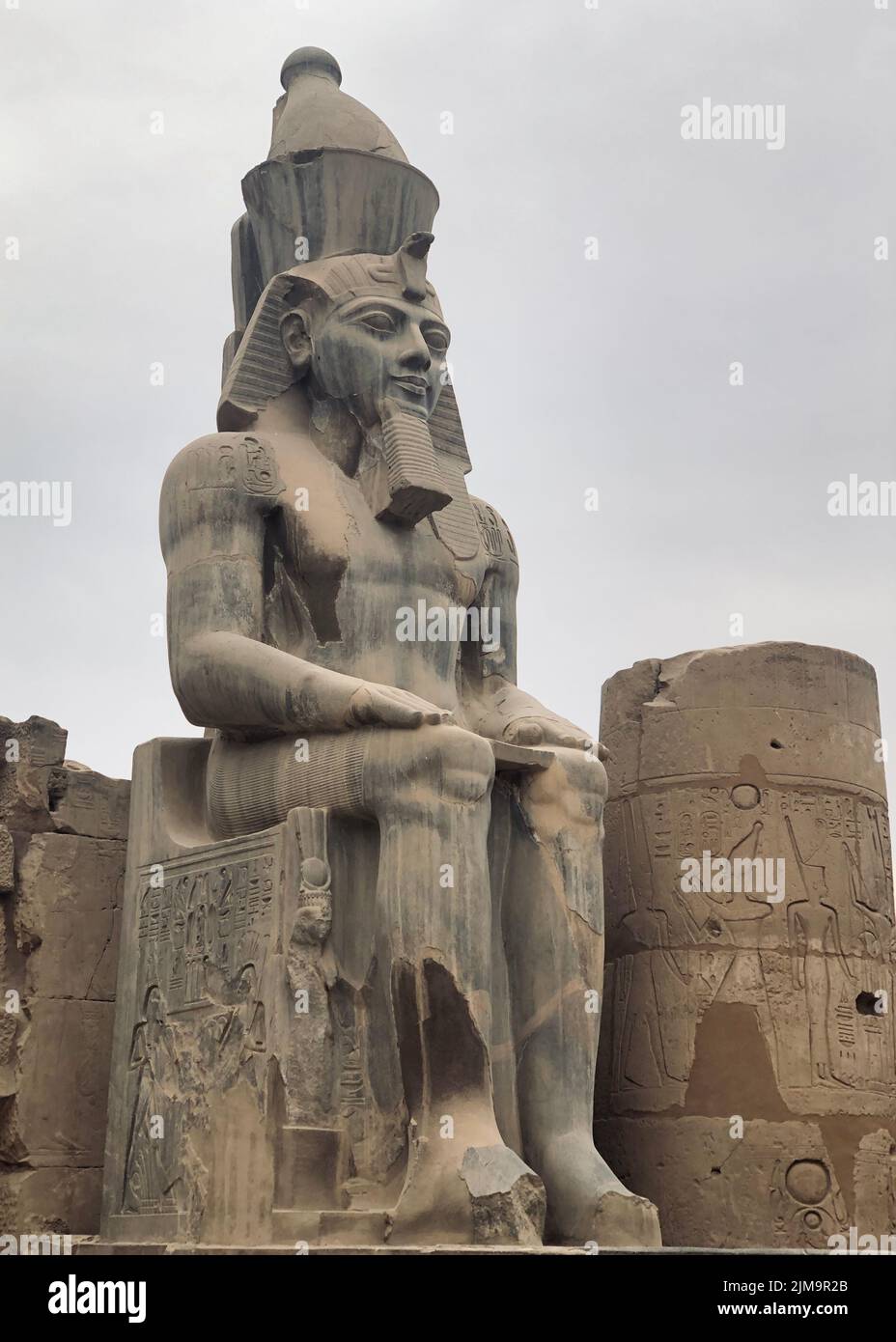 A vertical shot of a huge statue of Ramesses II in Luxor Temple, Egypt ...