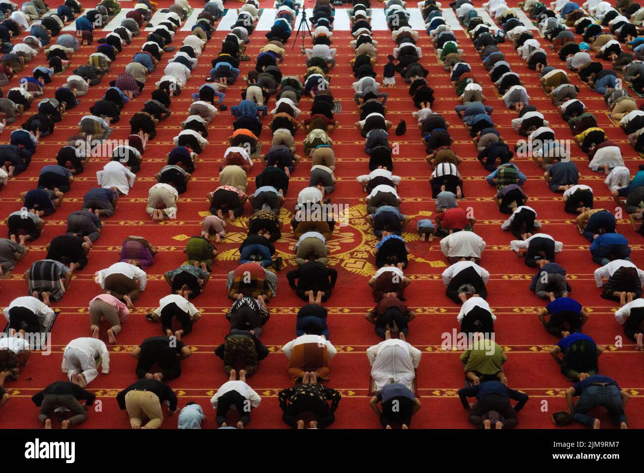 A muslims during prayer at the mosque ,on the red patterned mosque ...