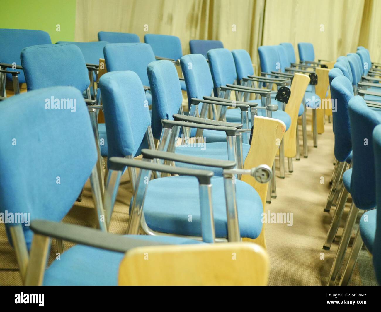A line of blue chairs arranged in the position of the array Stock Photo ...