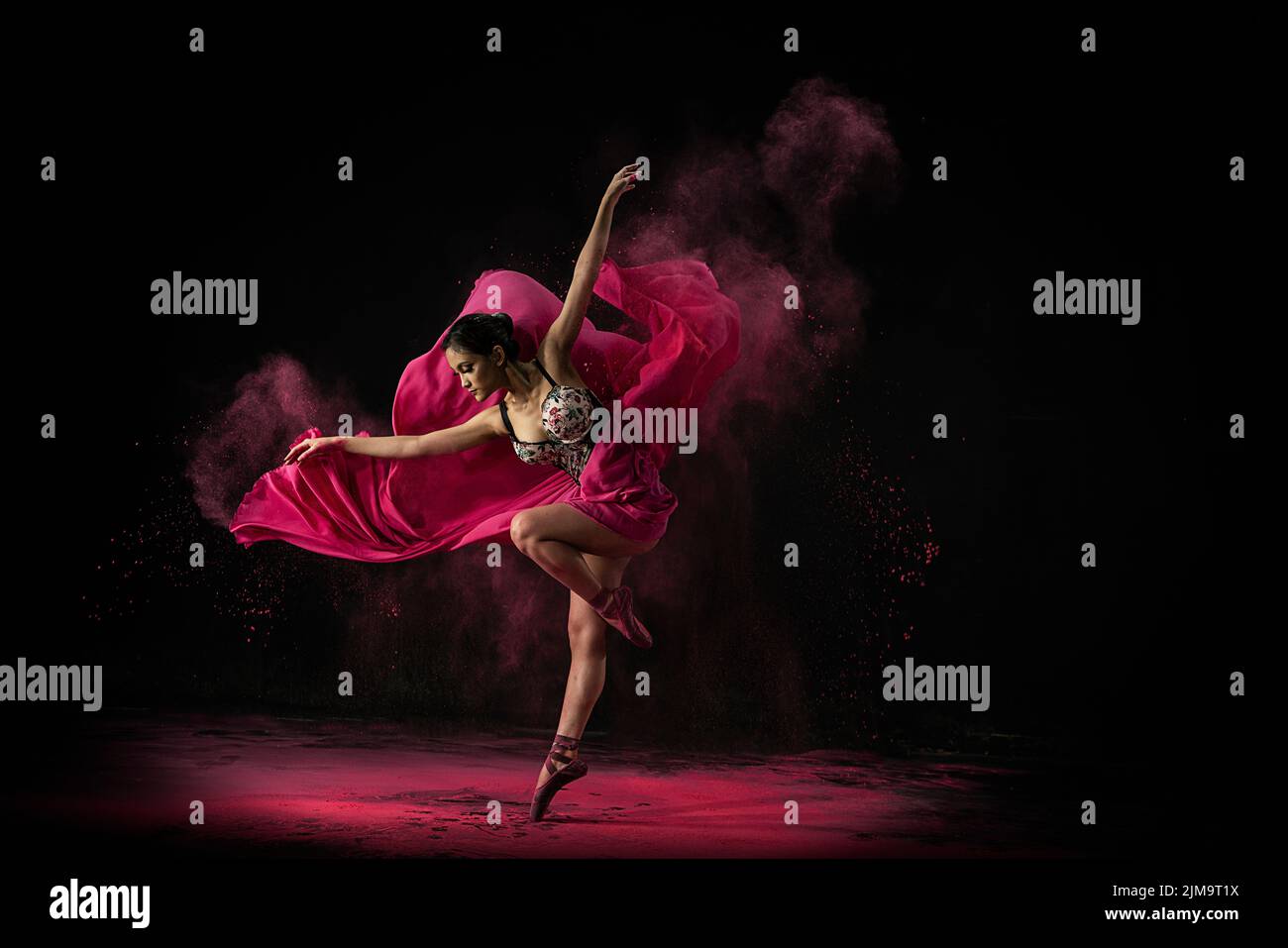 An emotional Southeast Asian ballet dancer in a red dress with powder ...