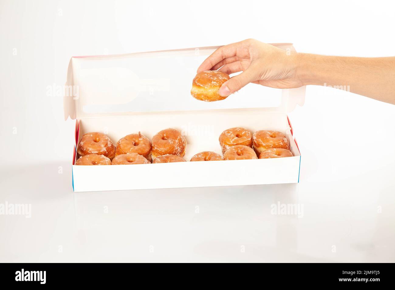 Box of twelve mini glazed brioche gourmet donuts Stock Photo - Alamy