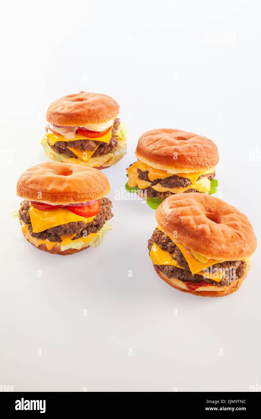 Four Brioche donut burgers deal meal Stock Photo - Alamy