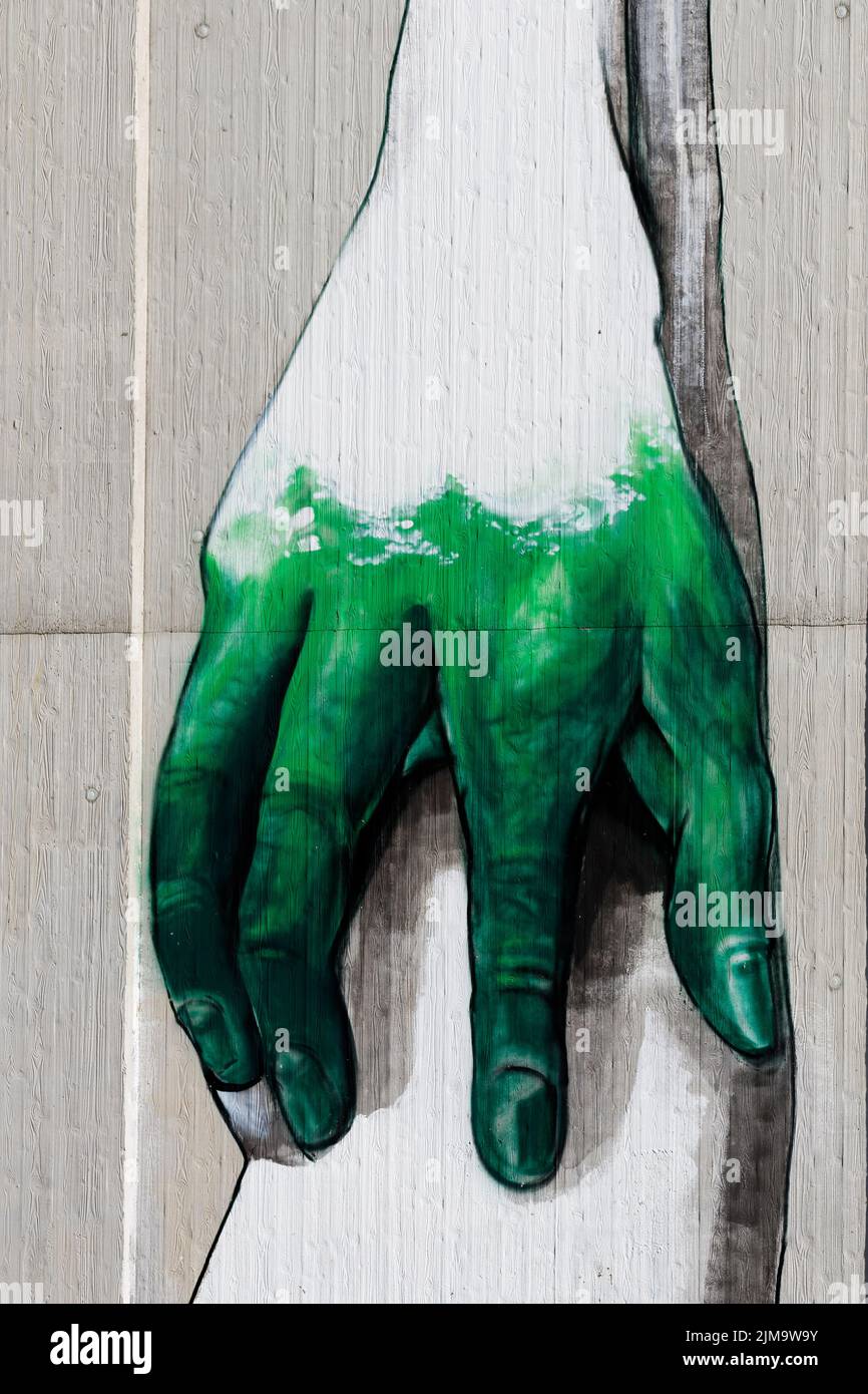 Wall with graffiti - Hand reaches out from a concrete wall Stock Photo ...