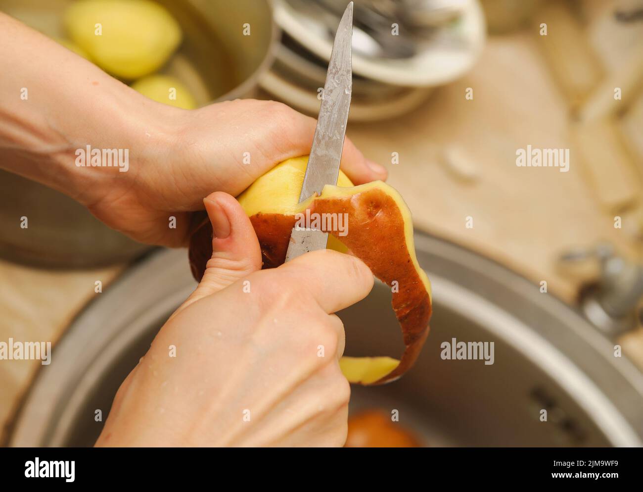 Woman cutting potato hi-res stock photography and images - Alamy