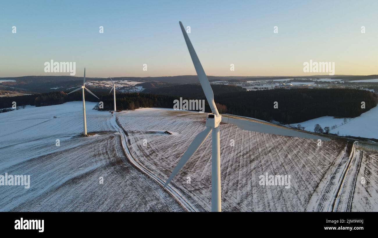 Wind turbines in a snowy field in Schnee Uberdeckt, Cologne, Germany ...