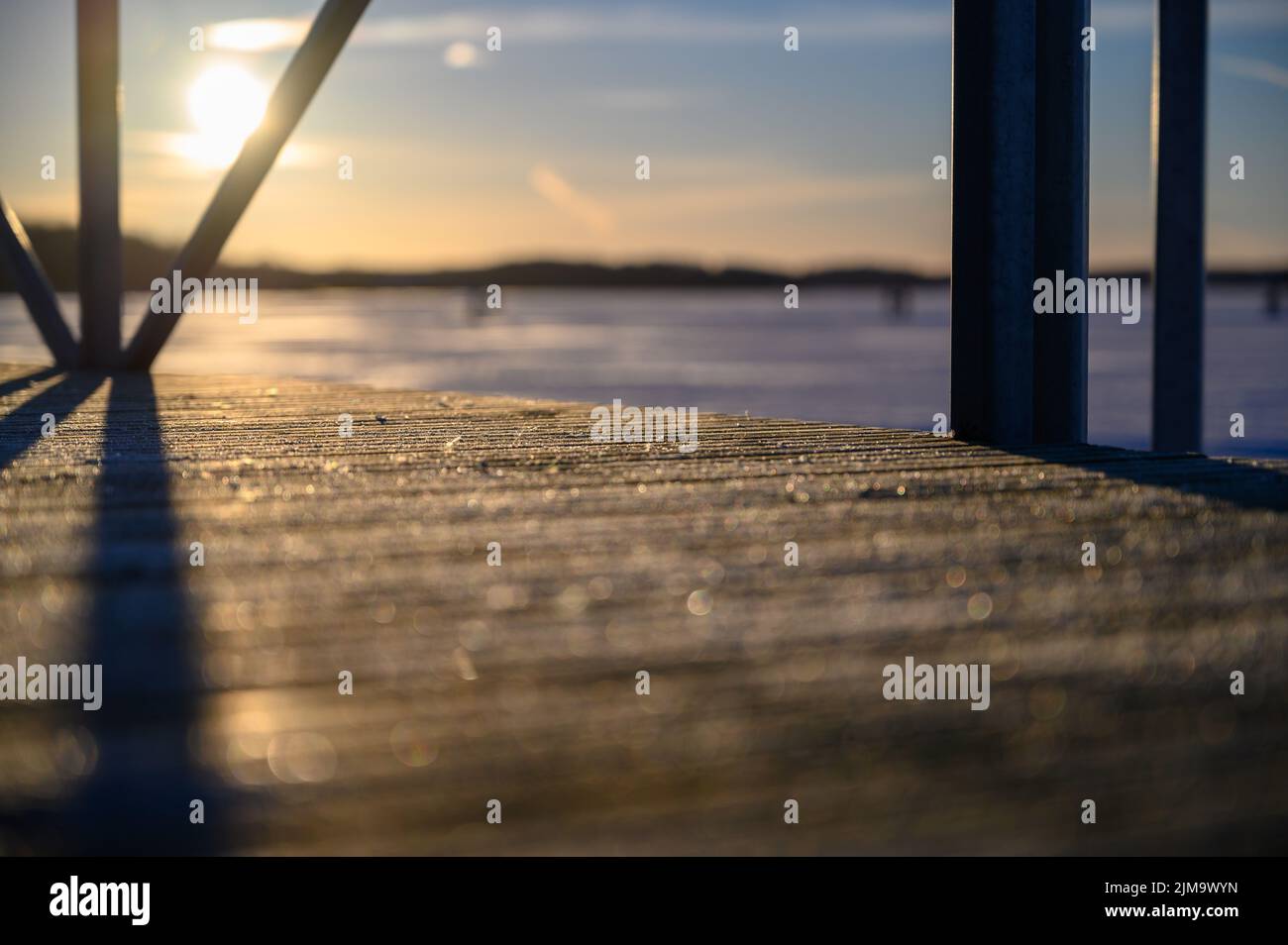 A frozen jetty during a sunny but cold day on a beach in the south of ...