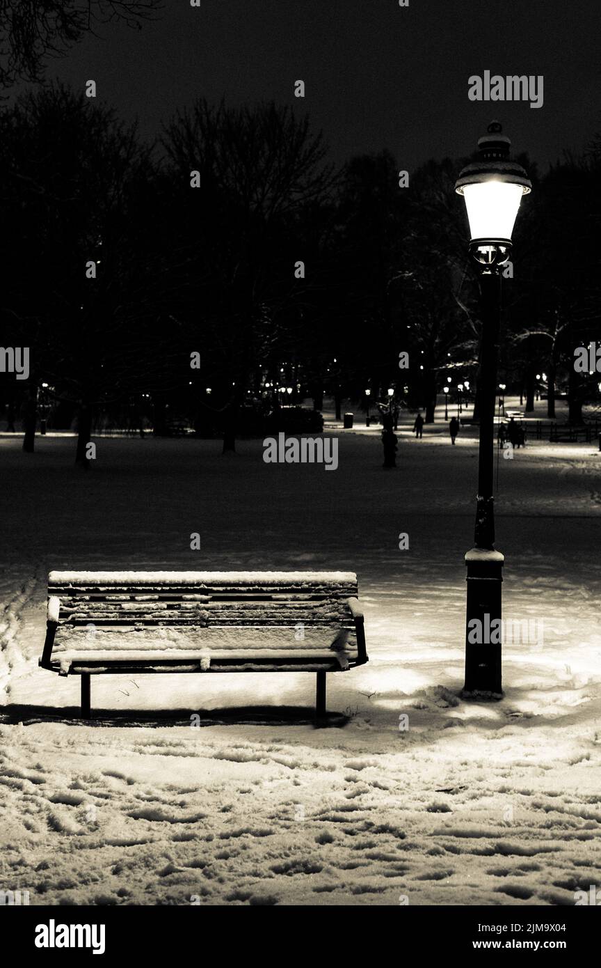 A lone bench under a lamp in Humlegarden, Stockholm, Sweden Stock Photo ...