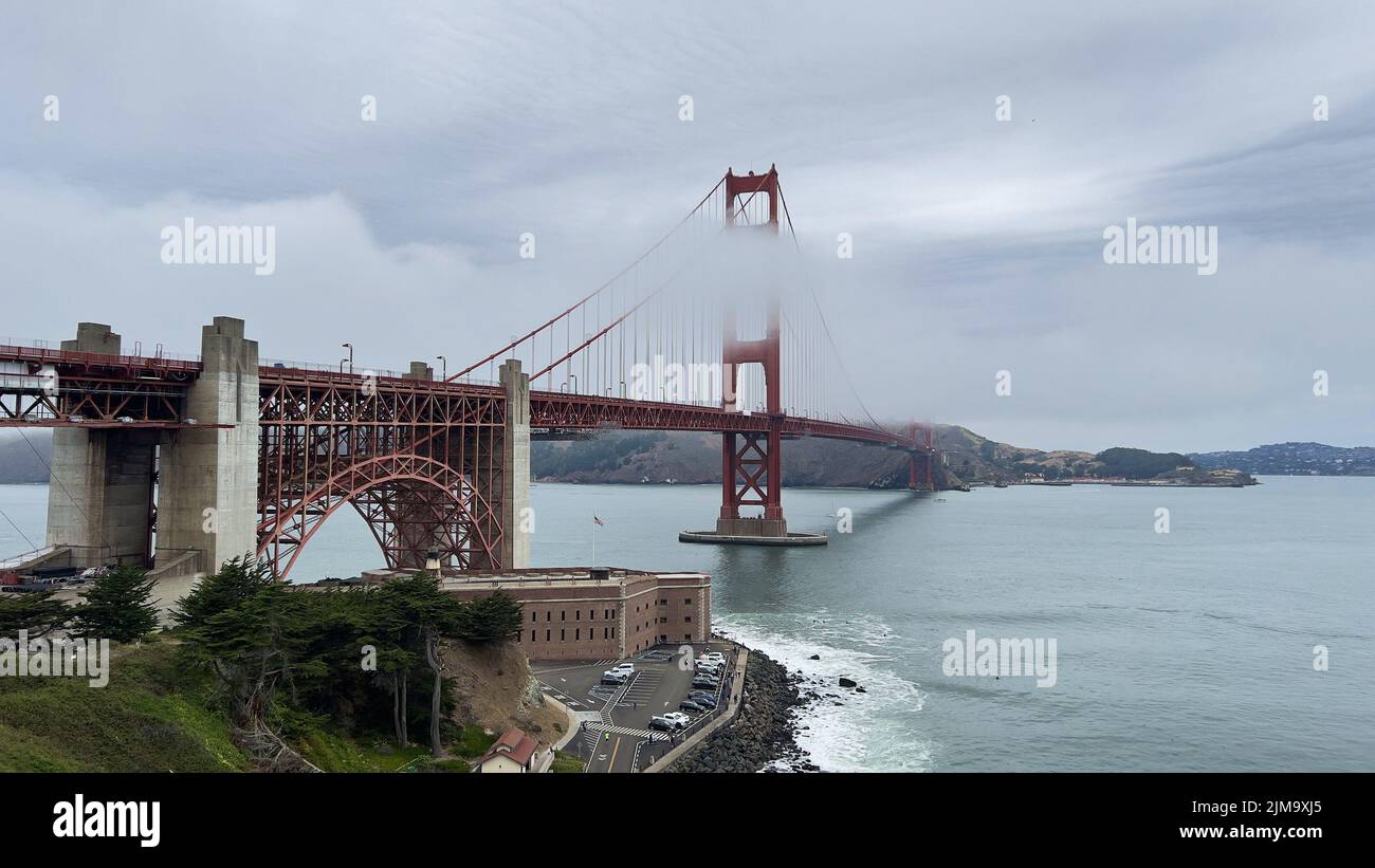 A view of the Golden Gate Bridge behind dense clouds, San Francisco ...