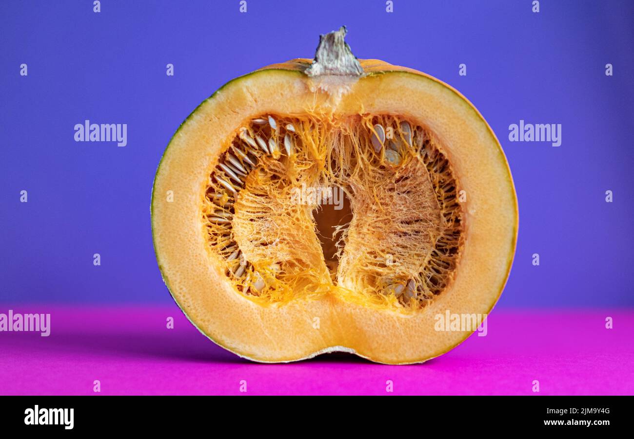 A ripe squash slice in half with colorful background Stock Photo - Alamy