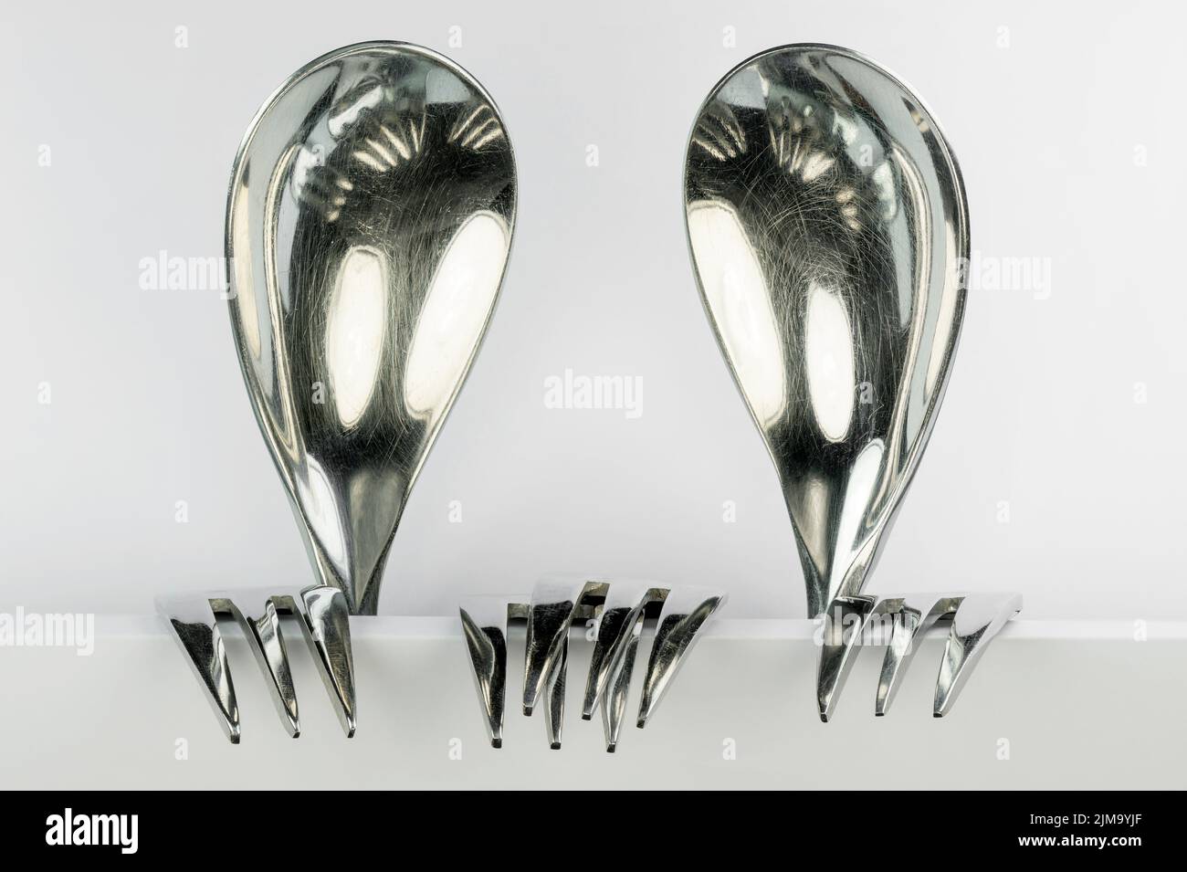 Two figures made of spoons and forks Stock Photo - Alamy