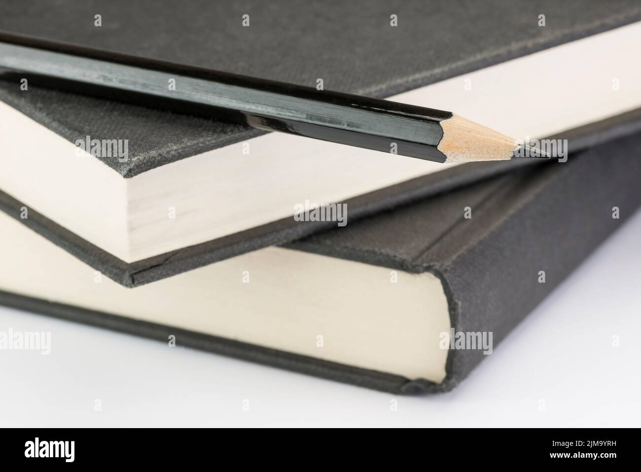 Books pencil hi-res stock photography and images - Alamy