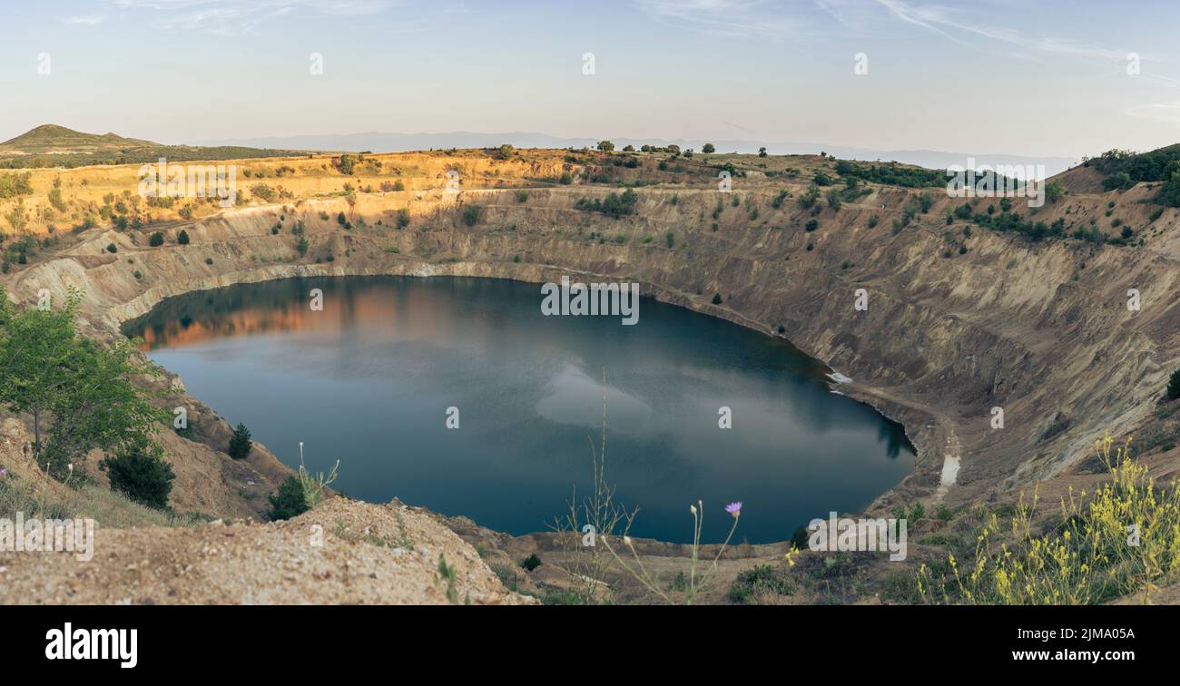 A blue lake in an open hole Stock Photo - Alamy