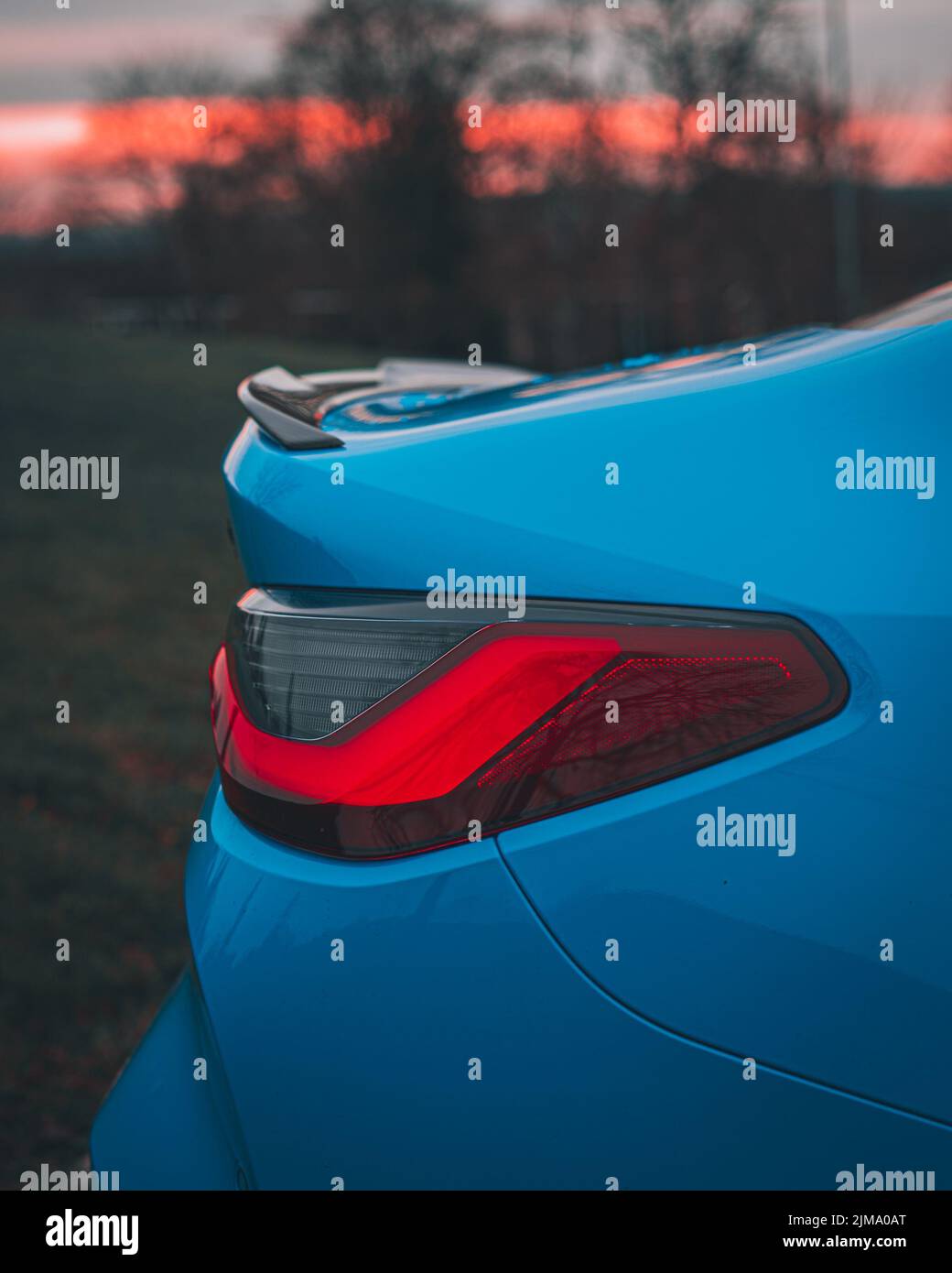 A vertical shot of a rear position lamp of a light blue shiny car Stock ...