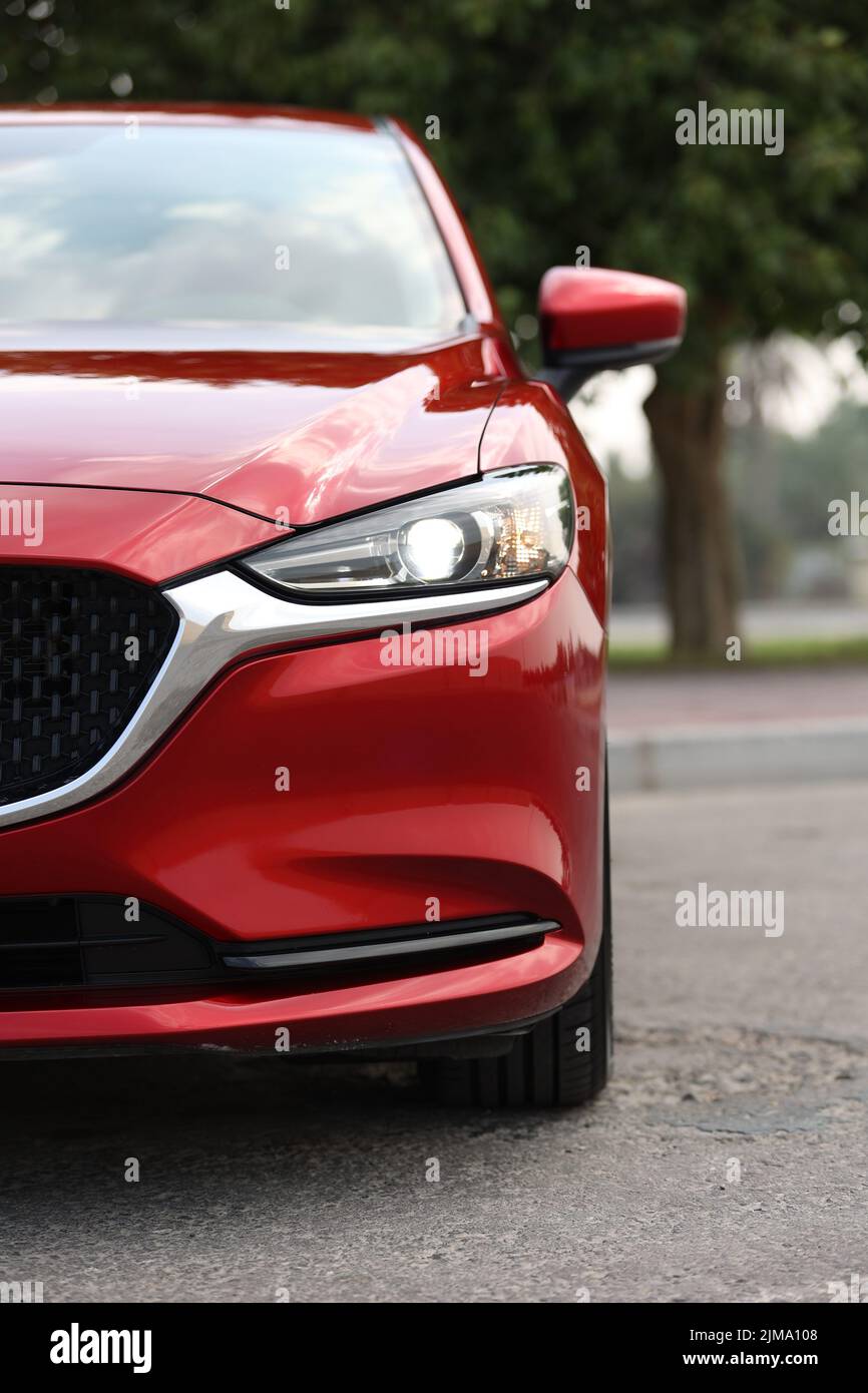 A vertical shot of a modern red car front view Stock Photo - Alamy