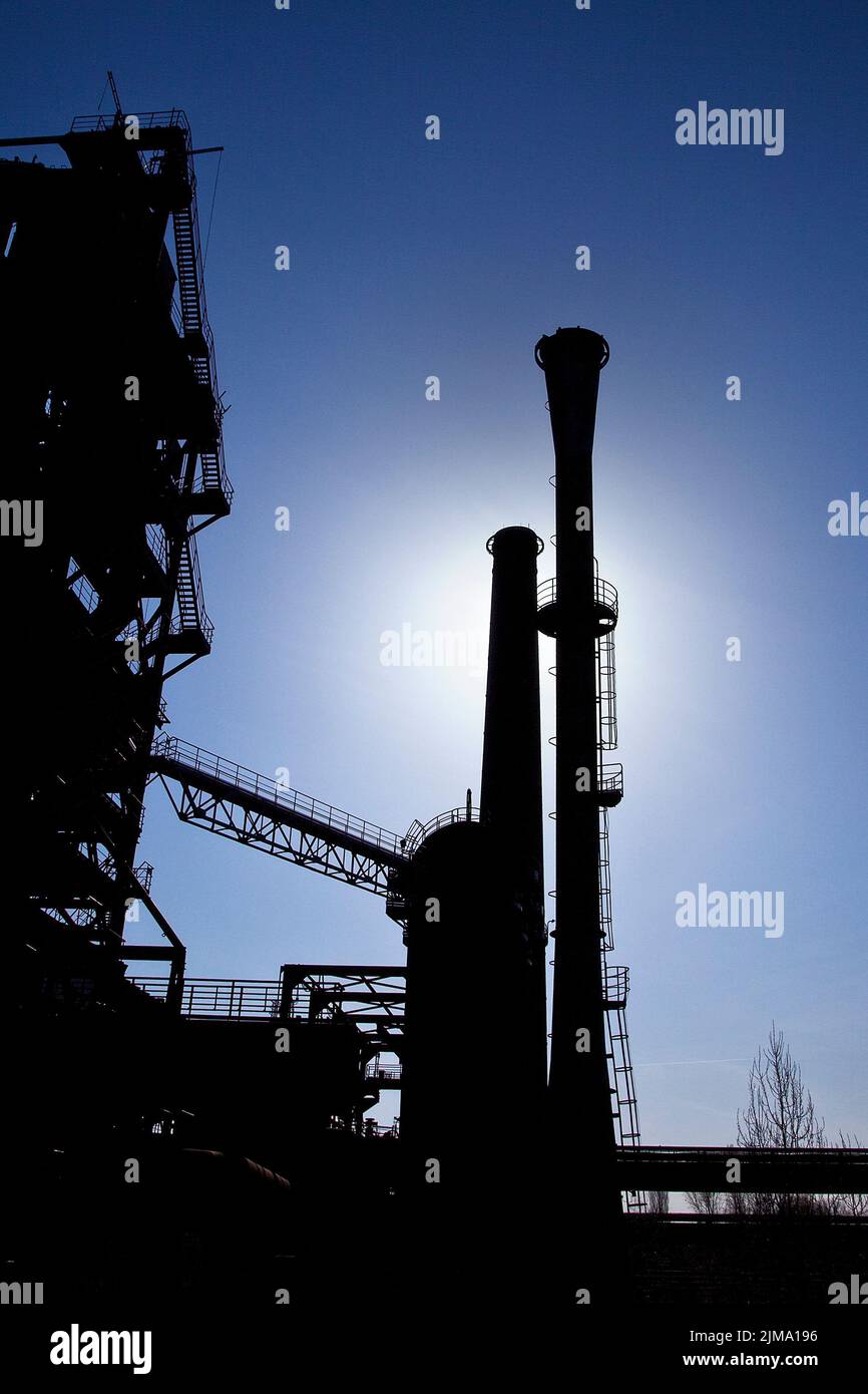 A silhouette view of a factory with blue sky background Stock Photo - Alamy