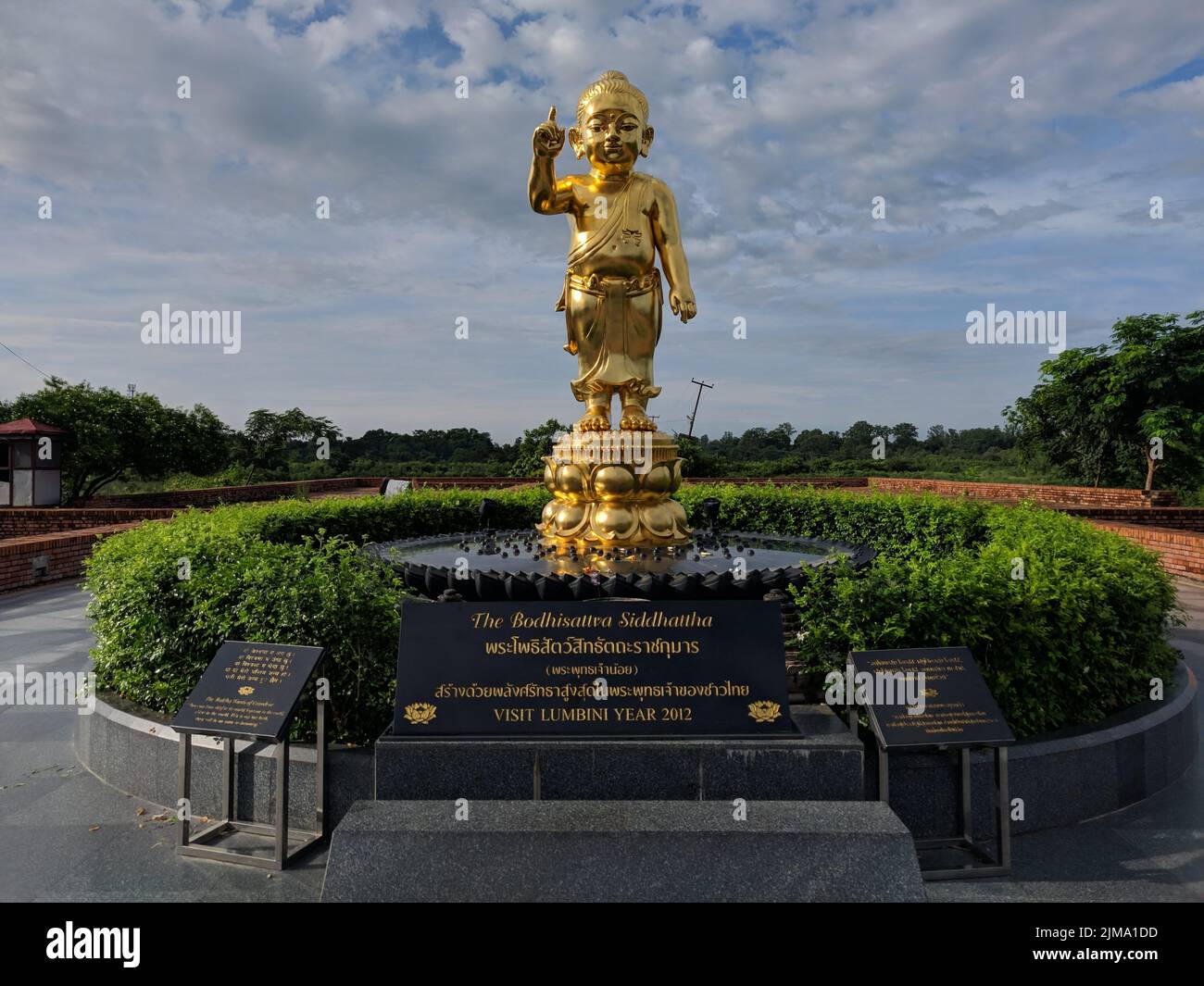 A large golden statue of peace symbol Gautam Buddha on a cloudy day ...