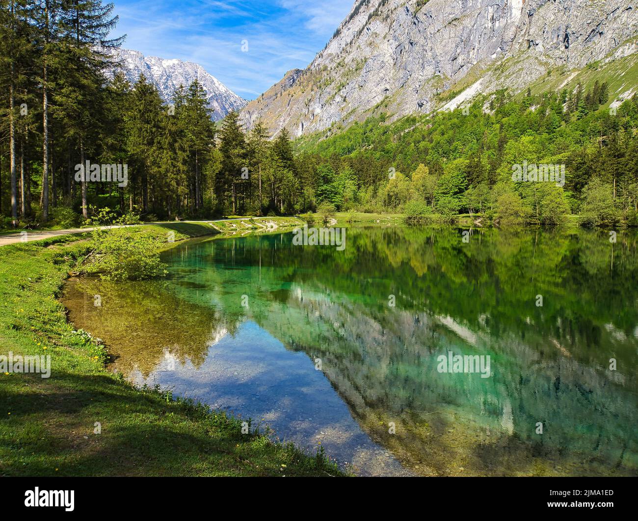 A beautiful view of the calm lake with reflection of trees in the water ...
