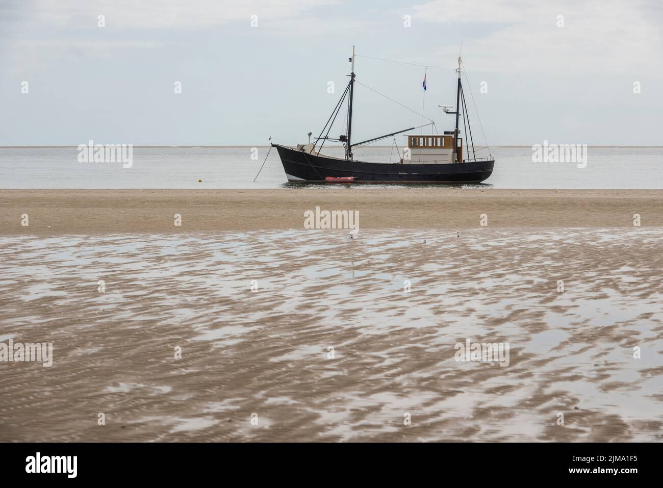 Fishing boat nearby the beach Stock Photo - Alamy