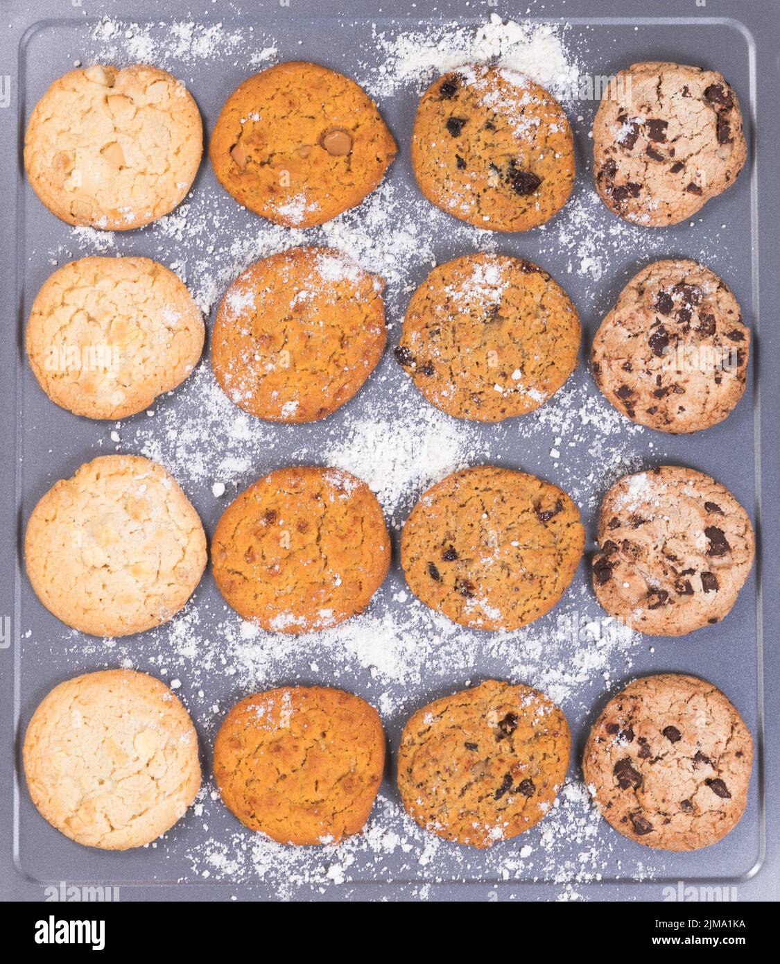 Variety of baked cookies with flour on baking sheet ready to eat Stock ...
