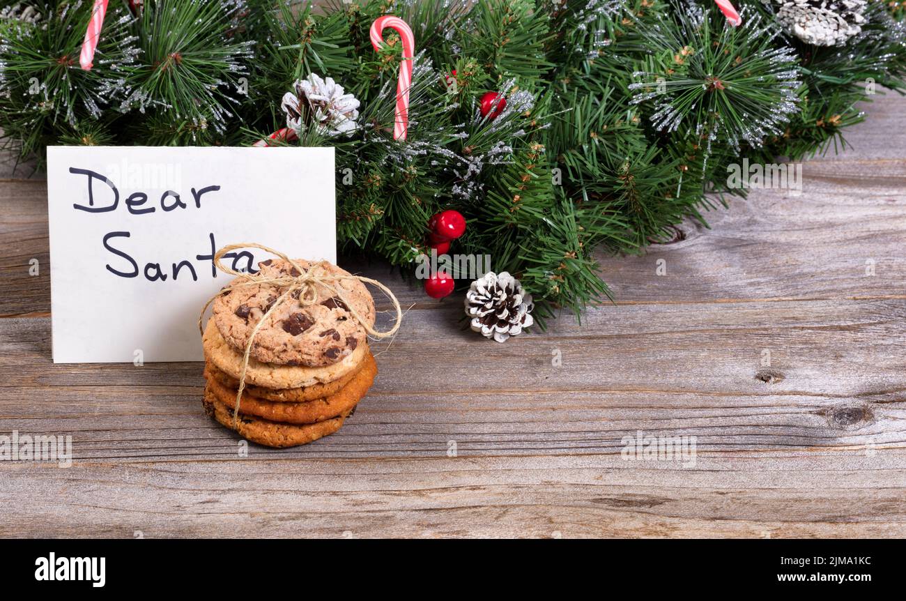 Stack of fresh cookies and card for Santa Claus with holiday ...